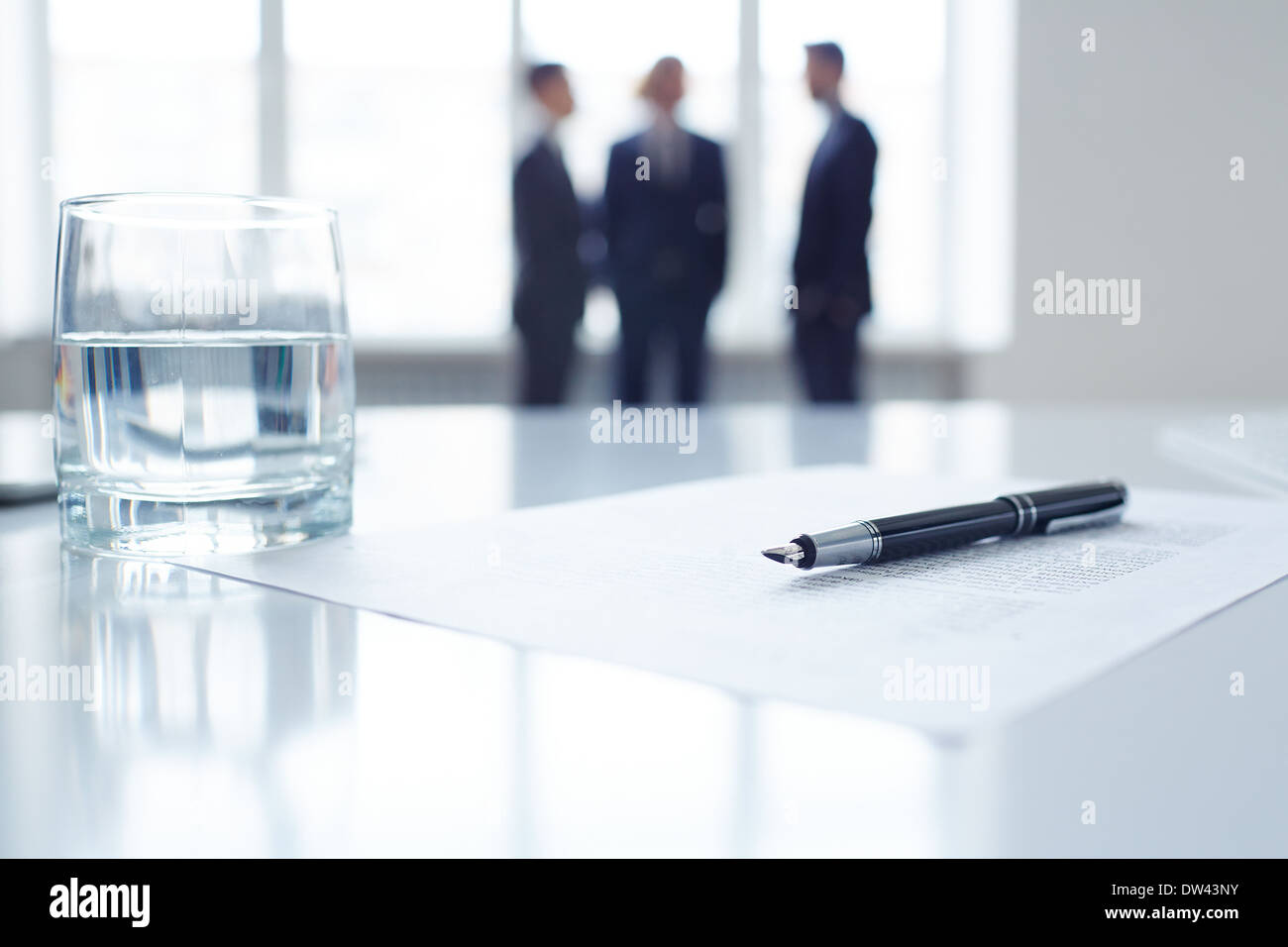 Image of business document, pen and glass of water at workplace with ...