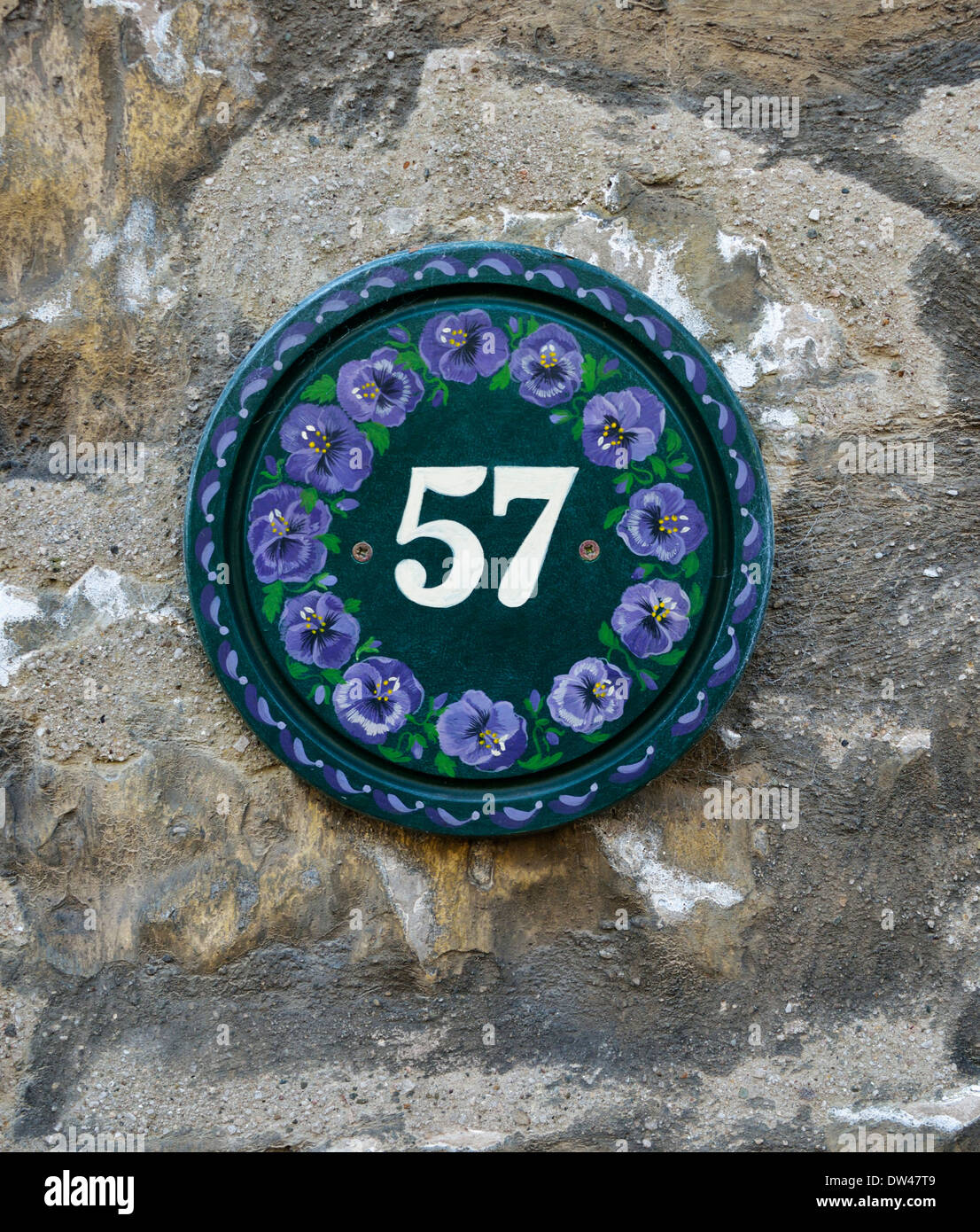 Number 57. House number on ceramic disk with flower design Stock Photo ...
