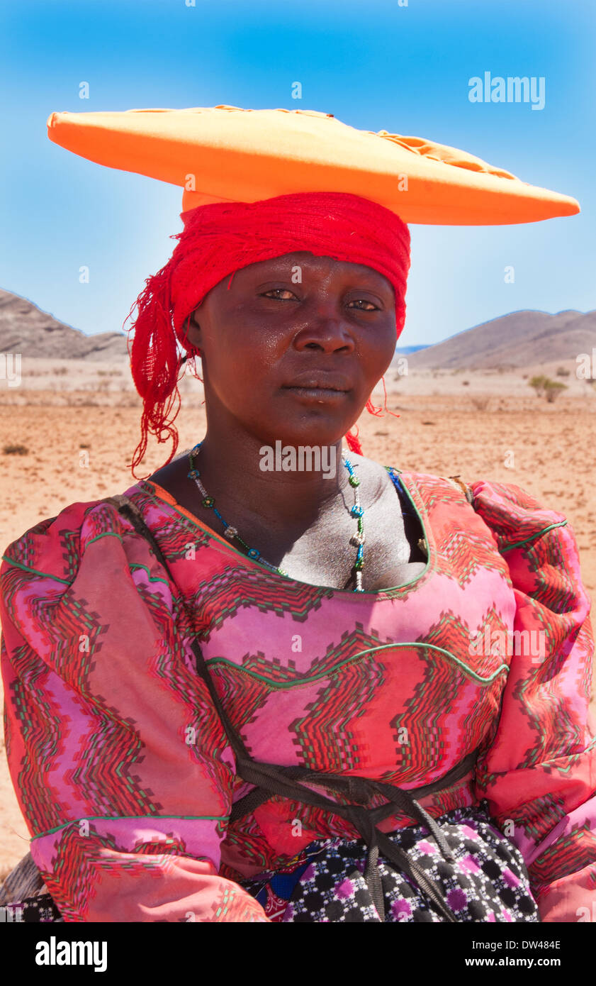 Namibia Africa Northern Desert Herero woman with hat riding mule ...