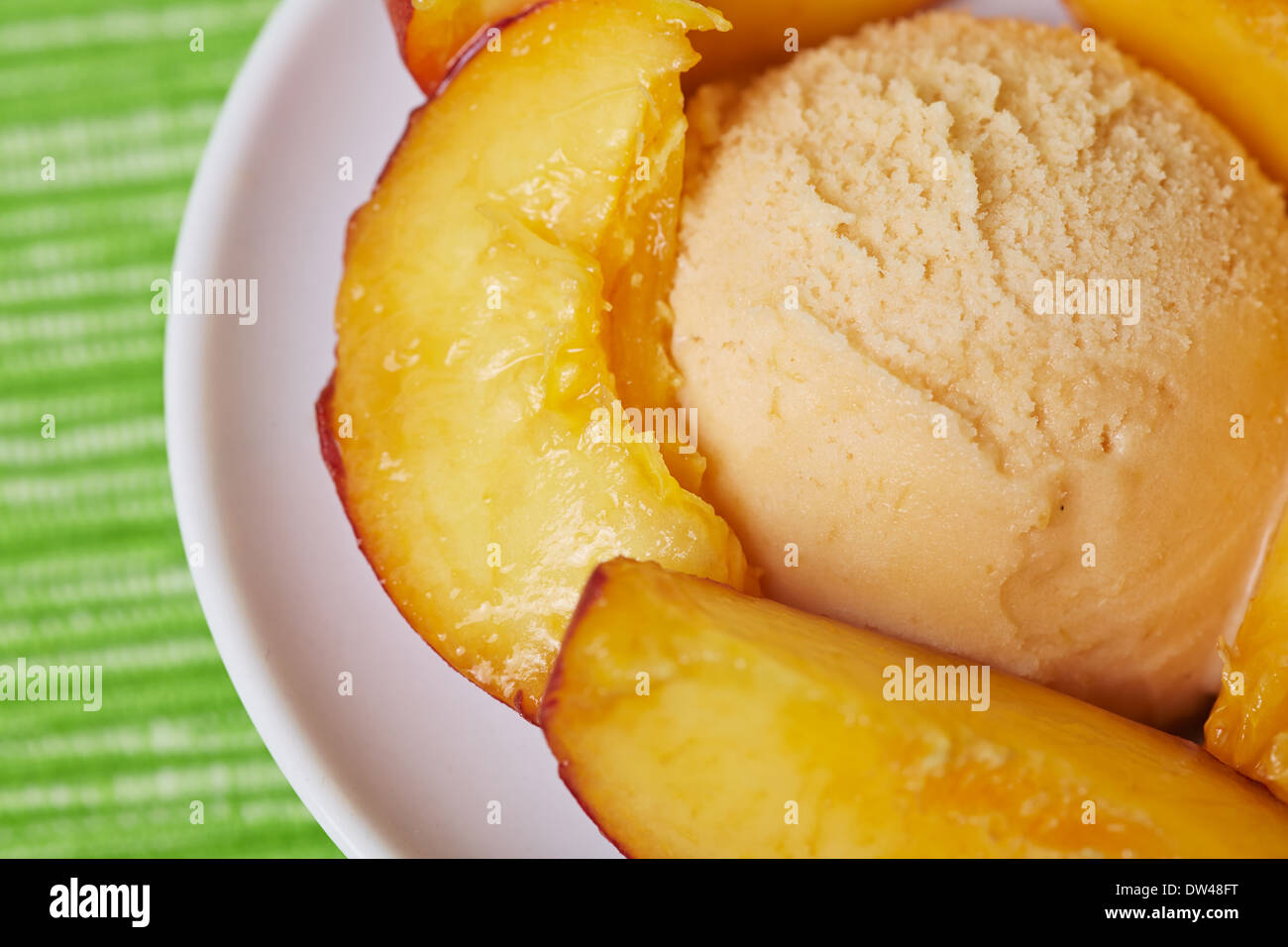 A scoop of homemade nectarine ice cream with fresh nectarines Stock ...