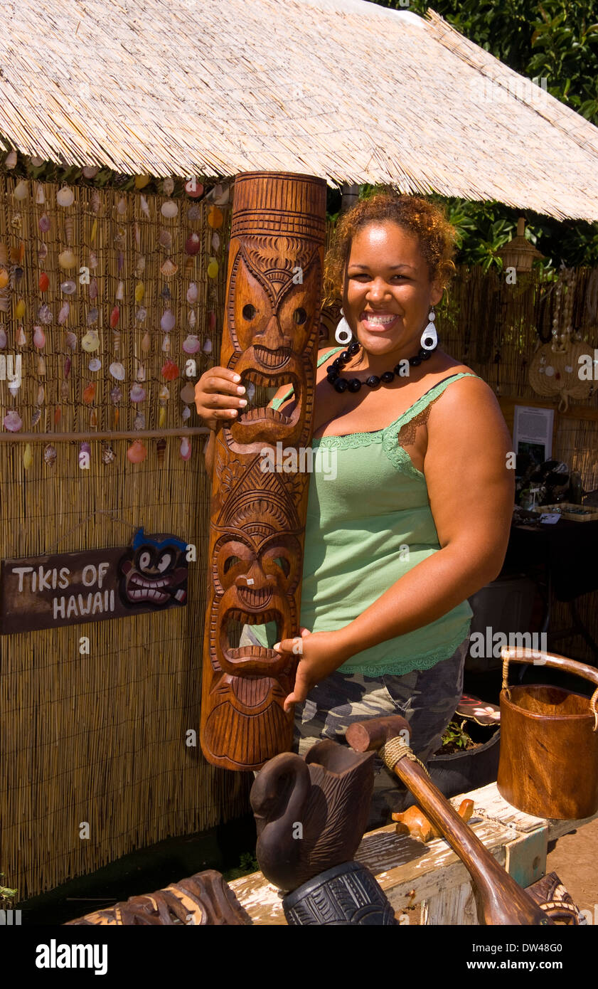 Portrait of native woman selling artwork crafts at market stand on road ...