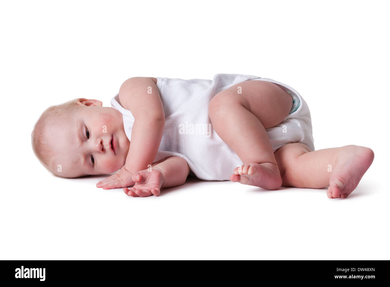 Cute little baby boy trying to roll over on white background Stock ...