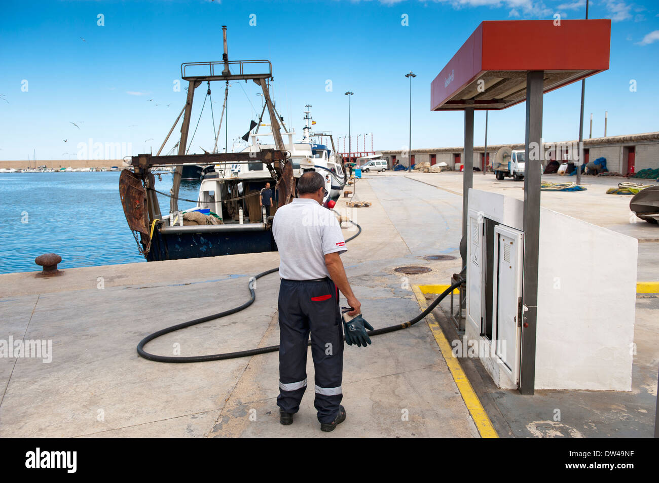 Refueling a trawler boat in port of Xabia, Spain Stock Photo - Alamy