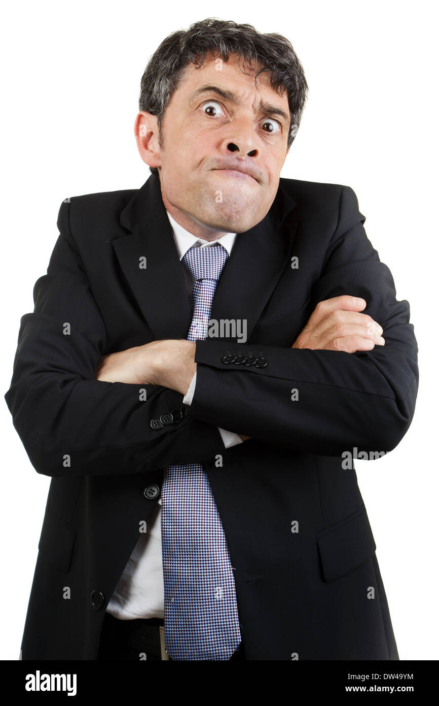 Businessman is pulling a face with arms crossed Stock Photo - Alamy
