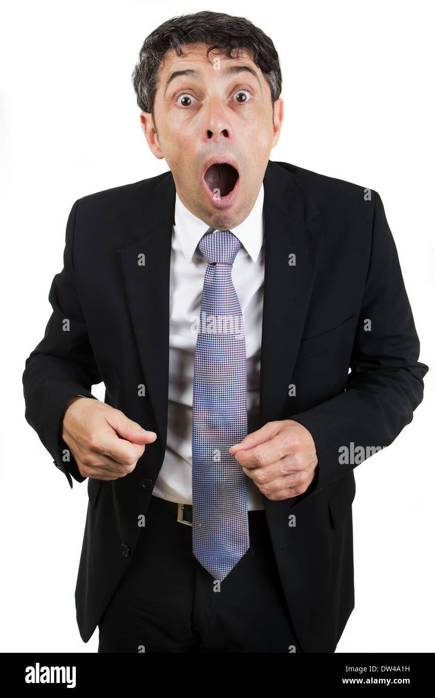 Businessman reacting in shocked horror or utter amazement standing with ...