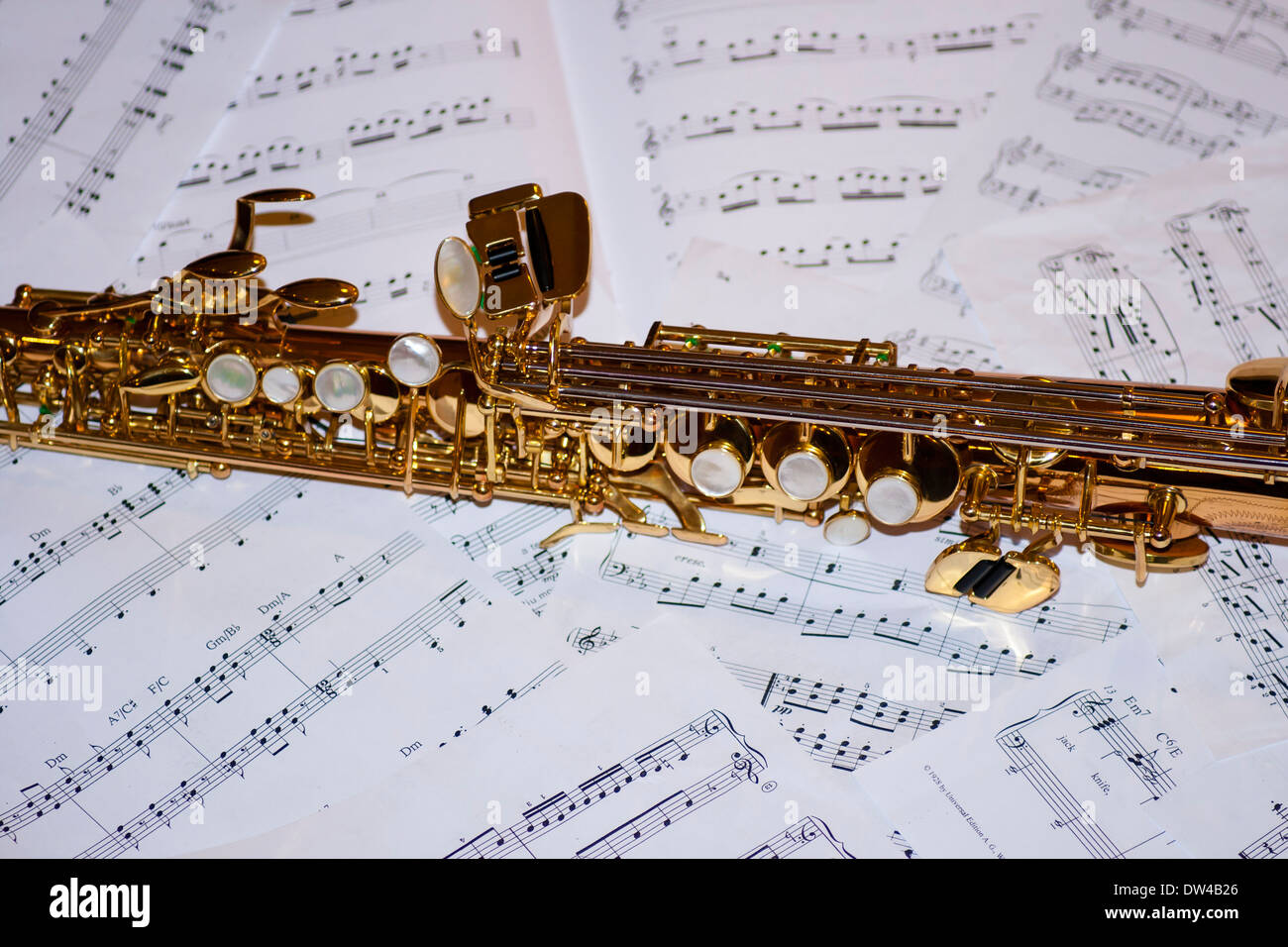 A soprano saxophone lying on sheet music Stock Photo - Alamy