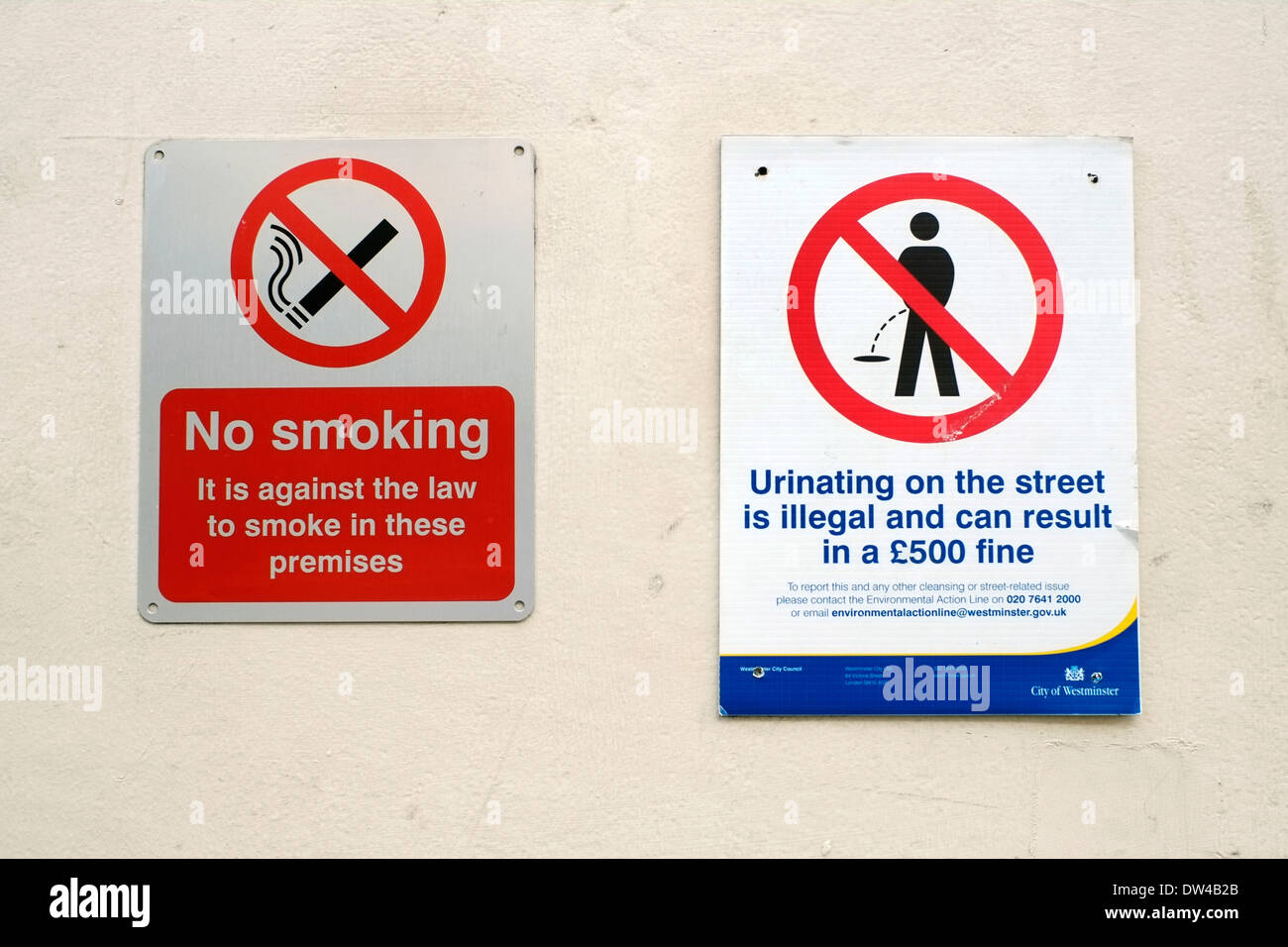 warning signs on wall advising of fine for urinating in the street and ...