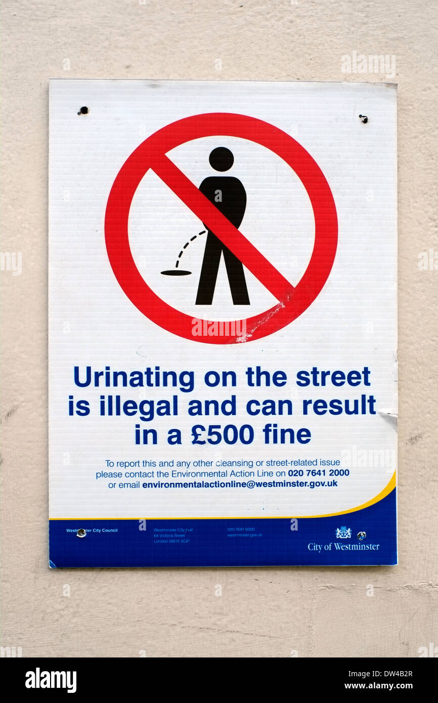 warning sign on wall advising of fine for urinating in the street Stock ...