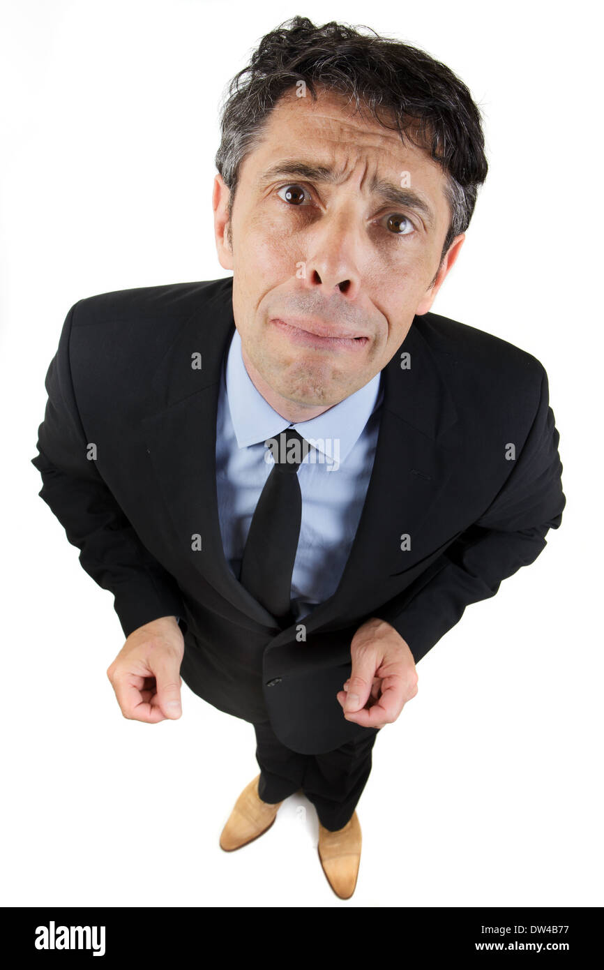 Upset sorrowful businessman standing looking up at the camera with a ...