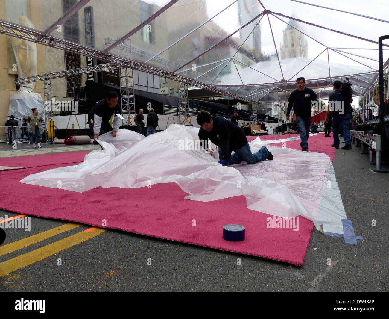 Employees from "American Turf & Carpet" install the red carpet for the ...