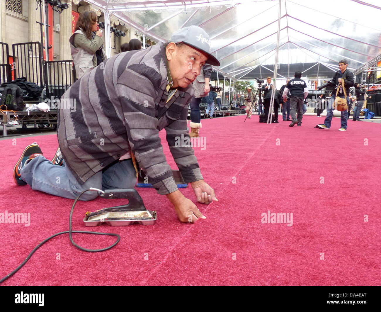 Employees from "American Turf & Carpet" install the red carpet for the ...