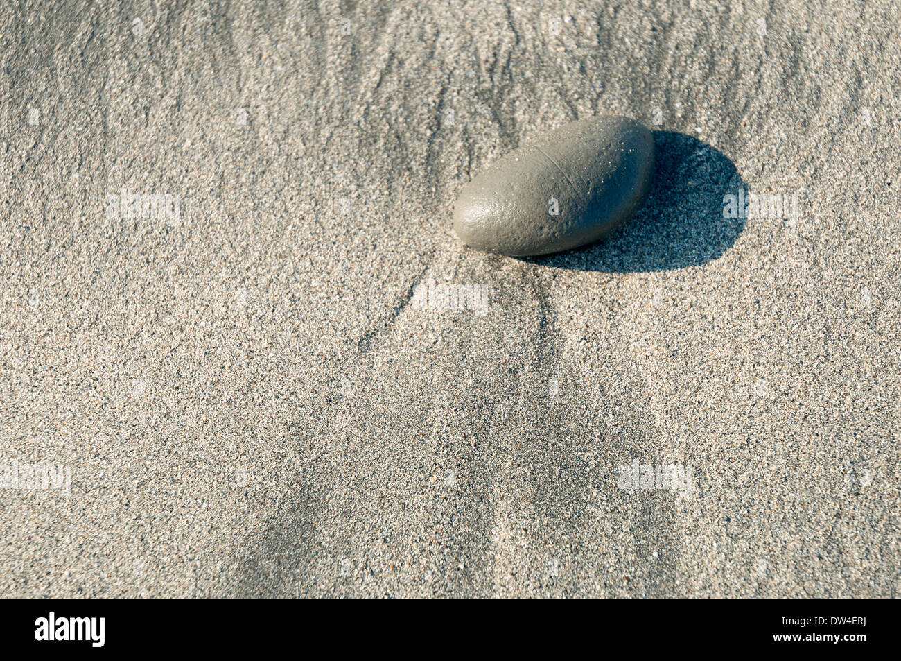 pebble on beach sand with surf traces Stock Photo - Alamy