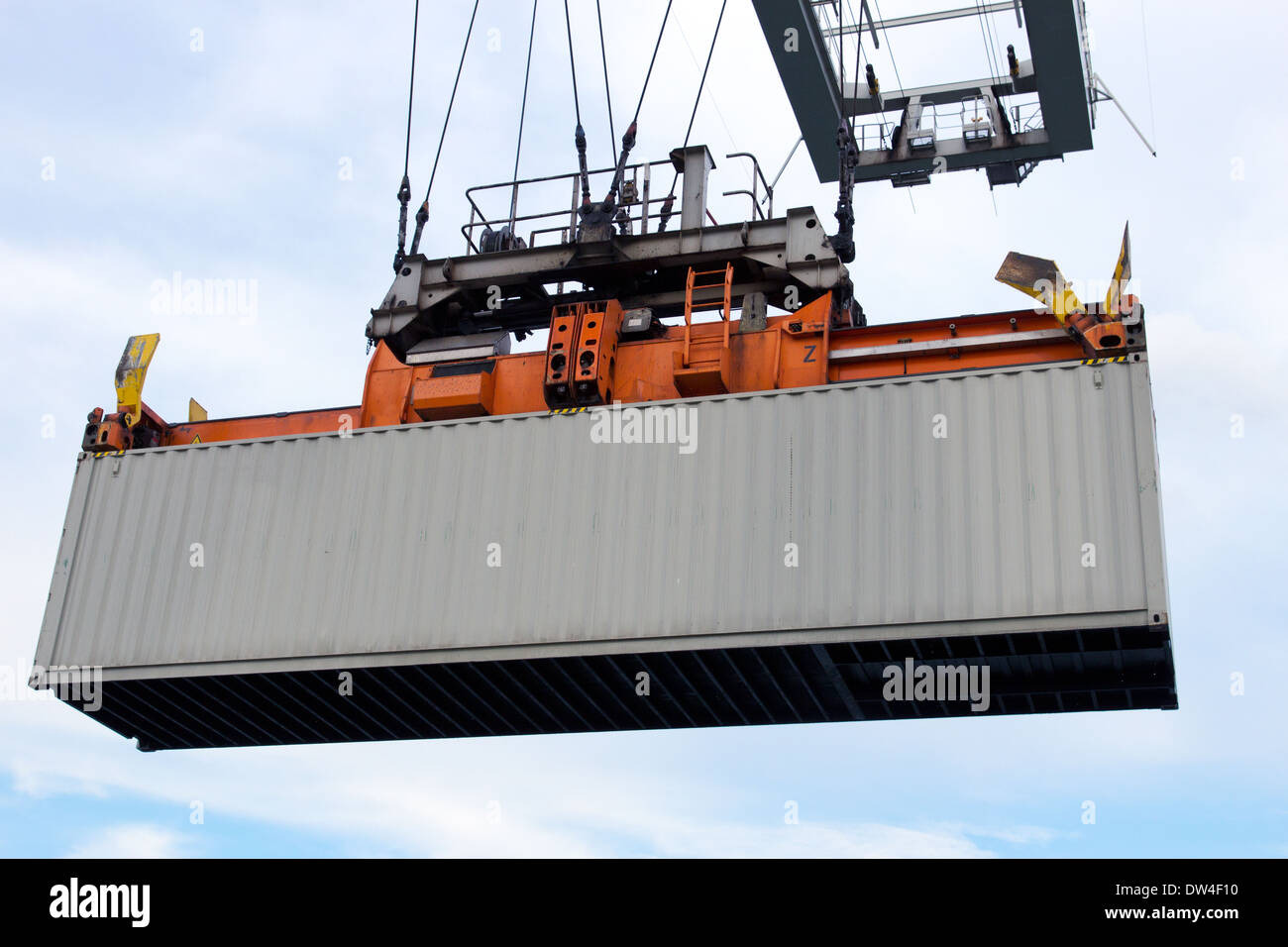 Sea container lifted by a harbor crane Stock Photo - Alamy