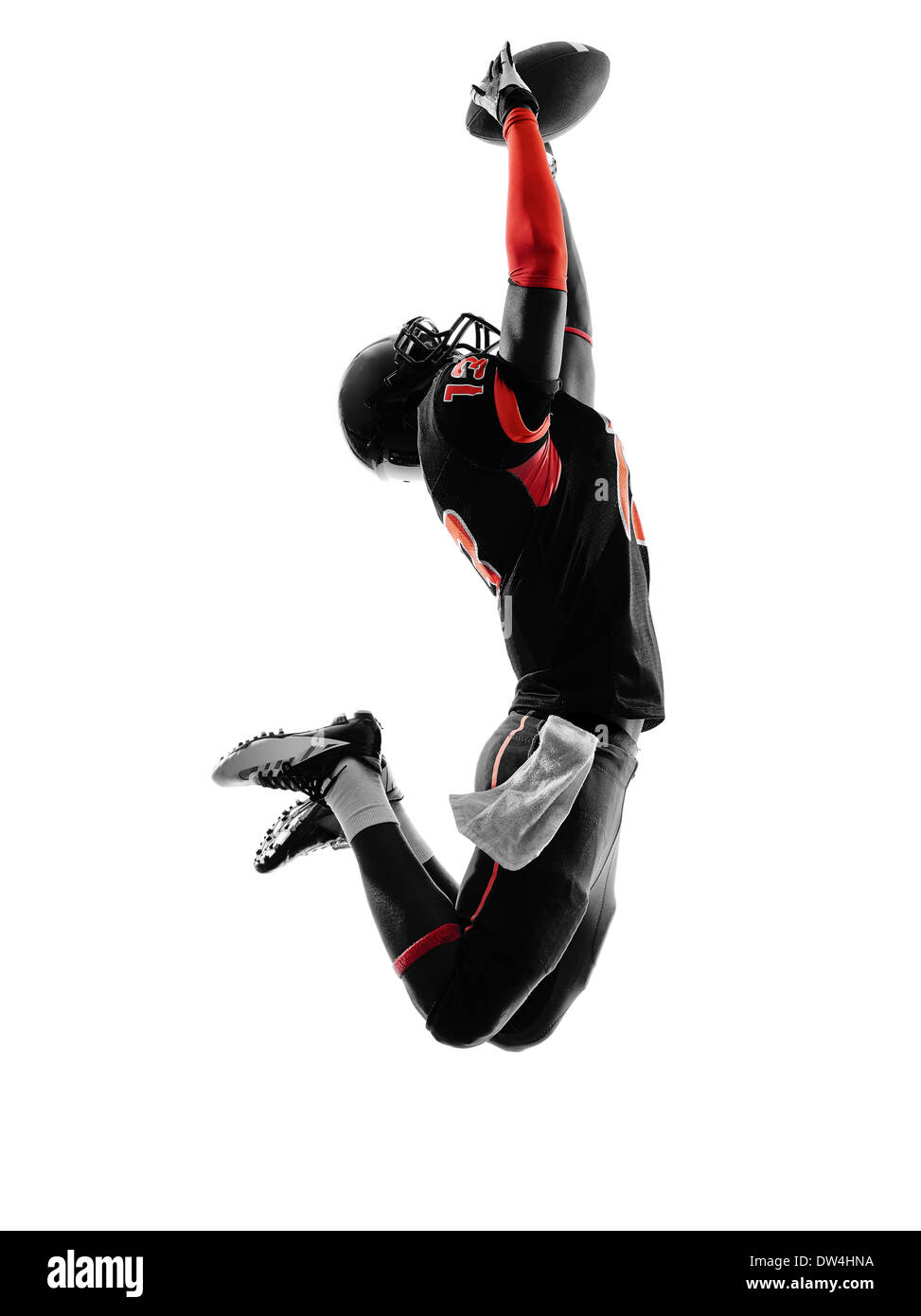 one american football player catching ball in silhouette shadow on ...