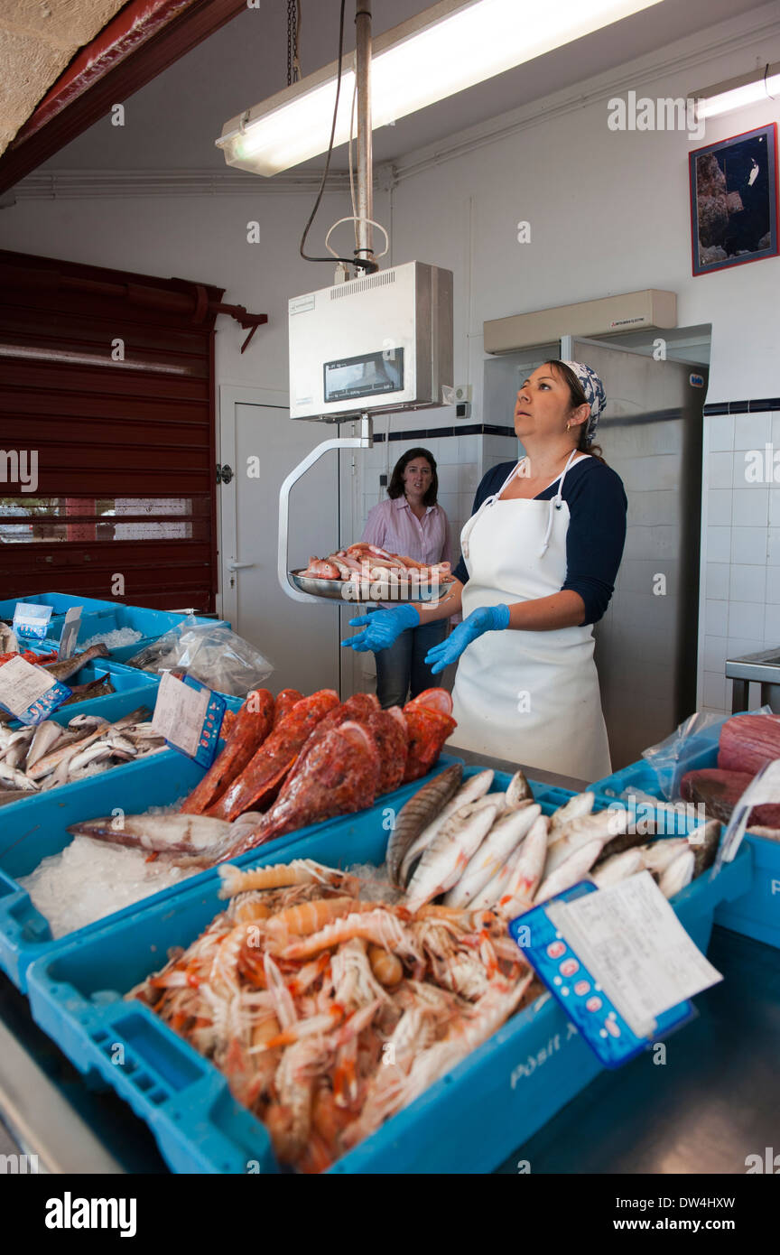 weighing freshly landed fish on market stall, Xabia, Spain Stock Photo ...