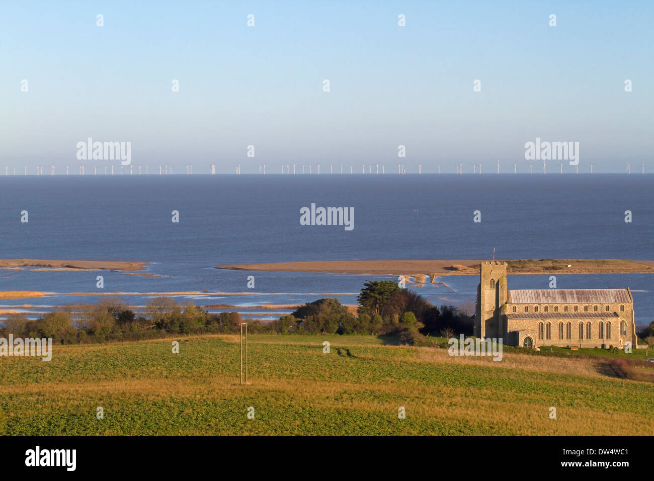 Major breach in shingle defence sea wall and church at Salthouse ...