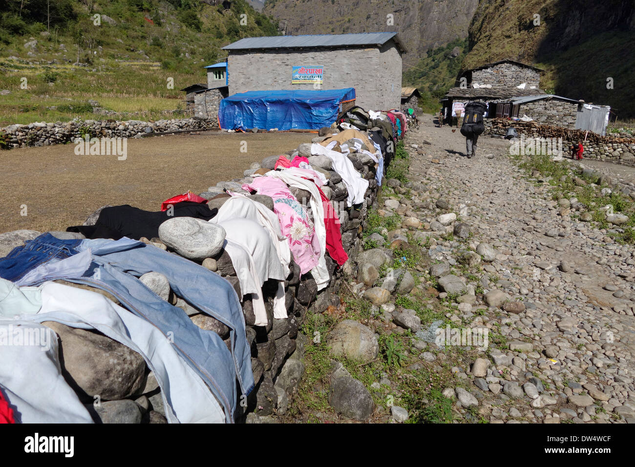 Clothes drying on a rock wall in the village of Jagat, Nepal Stock ...