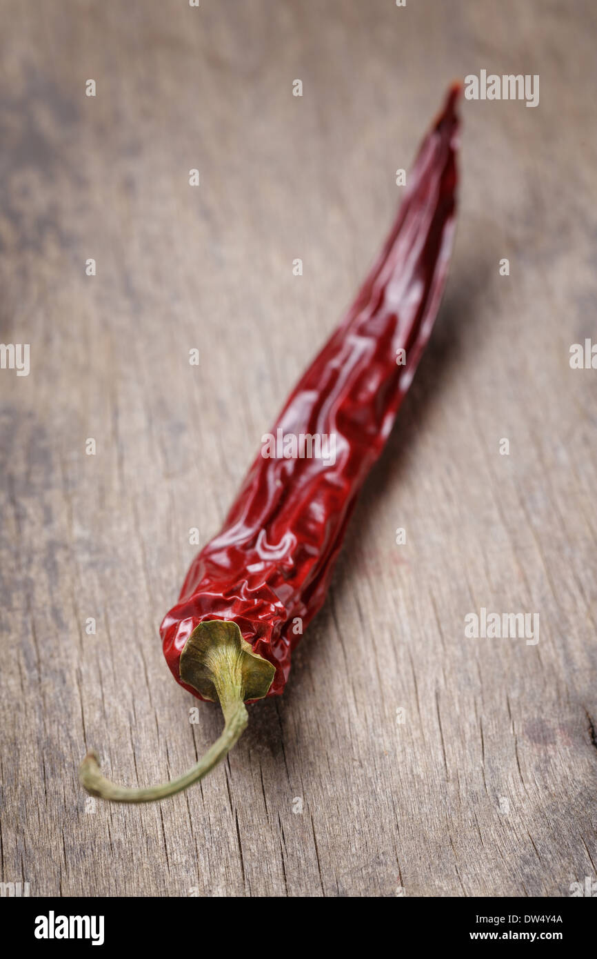 dried red chilli pepper on wood table, rustic style Stock Photo - Alamy