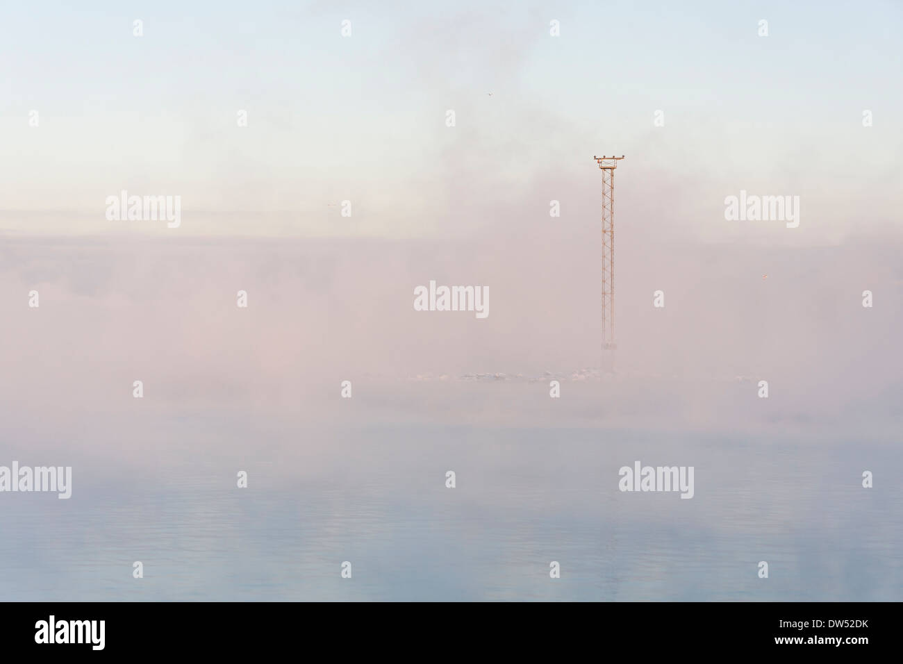 Mast in a deep mist in vapouring sea Stock Photo - Alamy