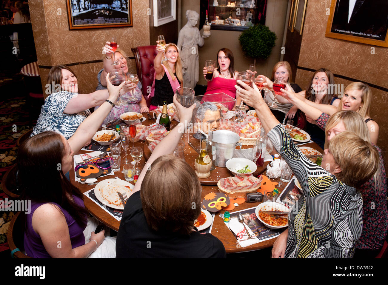 A group of women enjoying a pasta & pizza meal with drinks at the ...