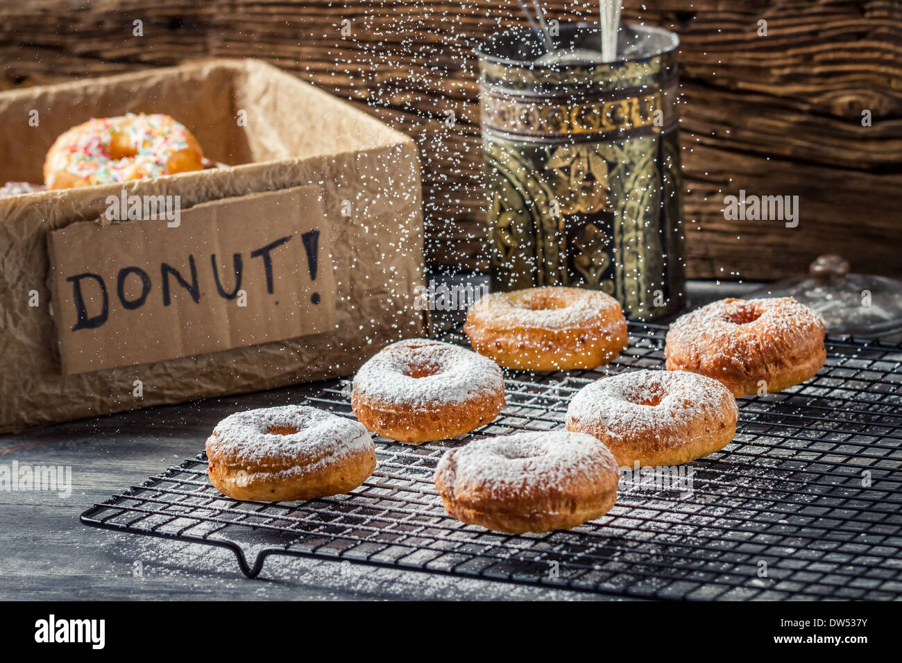 Falling icing sugar on fresh donuts Stock Photo - Alamy