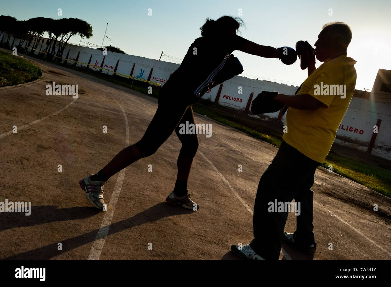 A Peruvian woman practices sparring with her coach in the outdoor ...