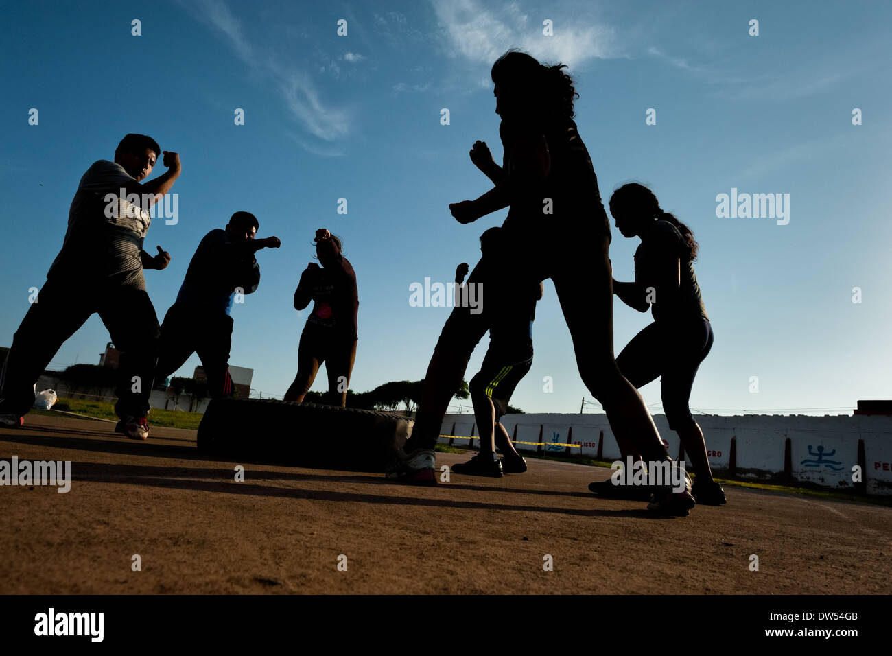 Peruvian youths practice shadowboxing while training in the outdoor ...