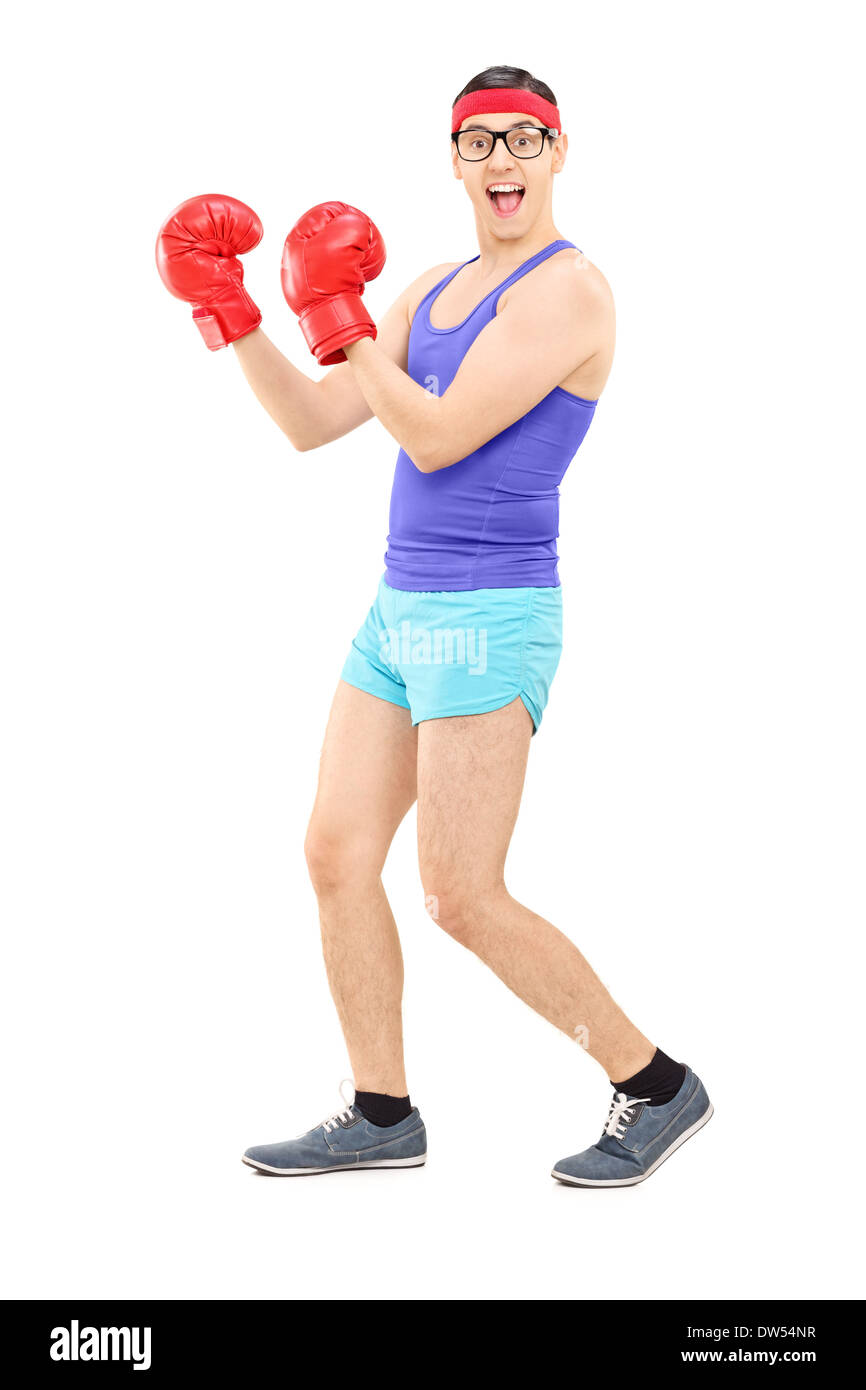 Full length portrait of a young man with boxing gloves posing for the ...