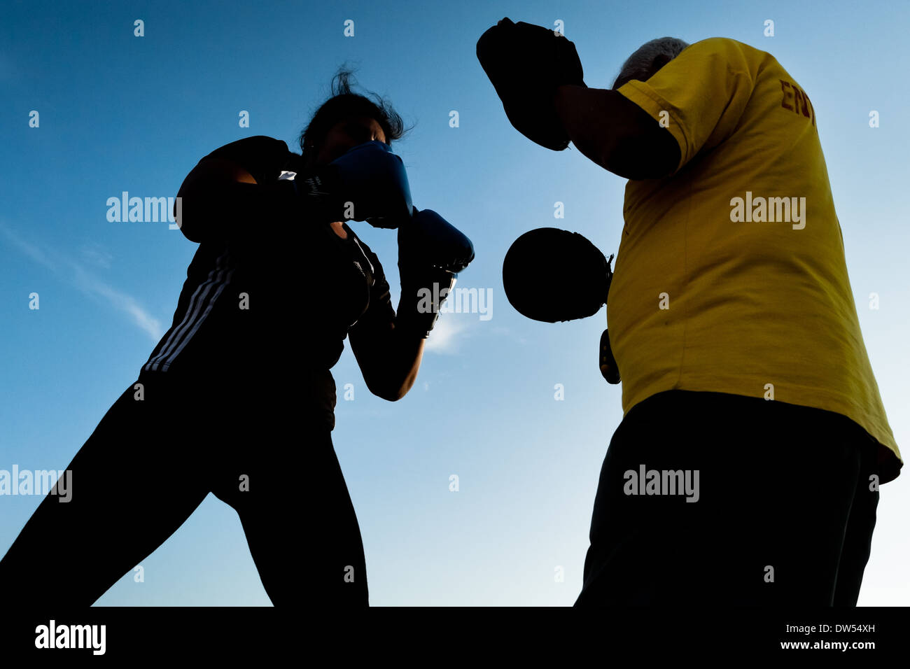 A Peruvian woman is seen during the sparring workout with her coach in ...