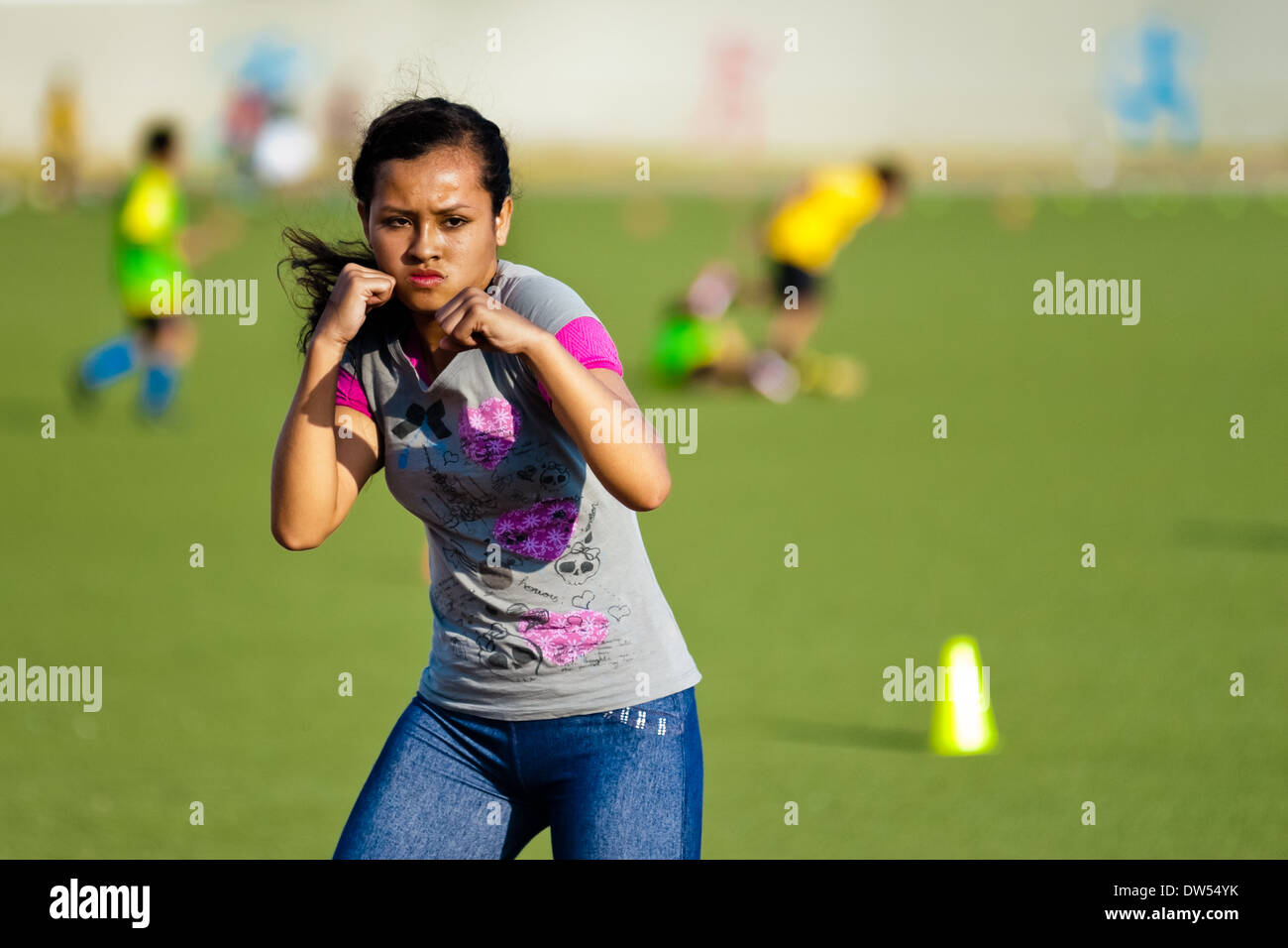 A young Peruvian girl practices shadowboxing while training in the ...