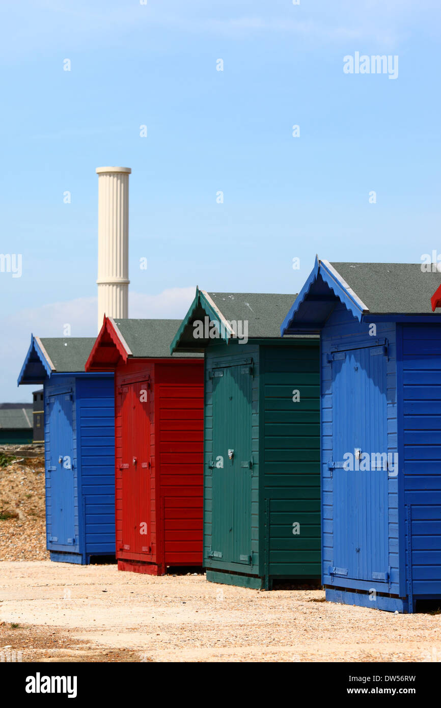 Line of wooden beach huts on sea front and modern Grecian style column ...