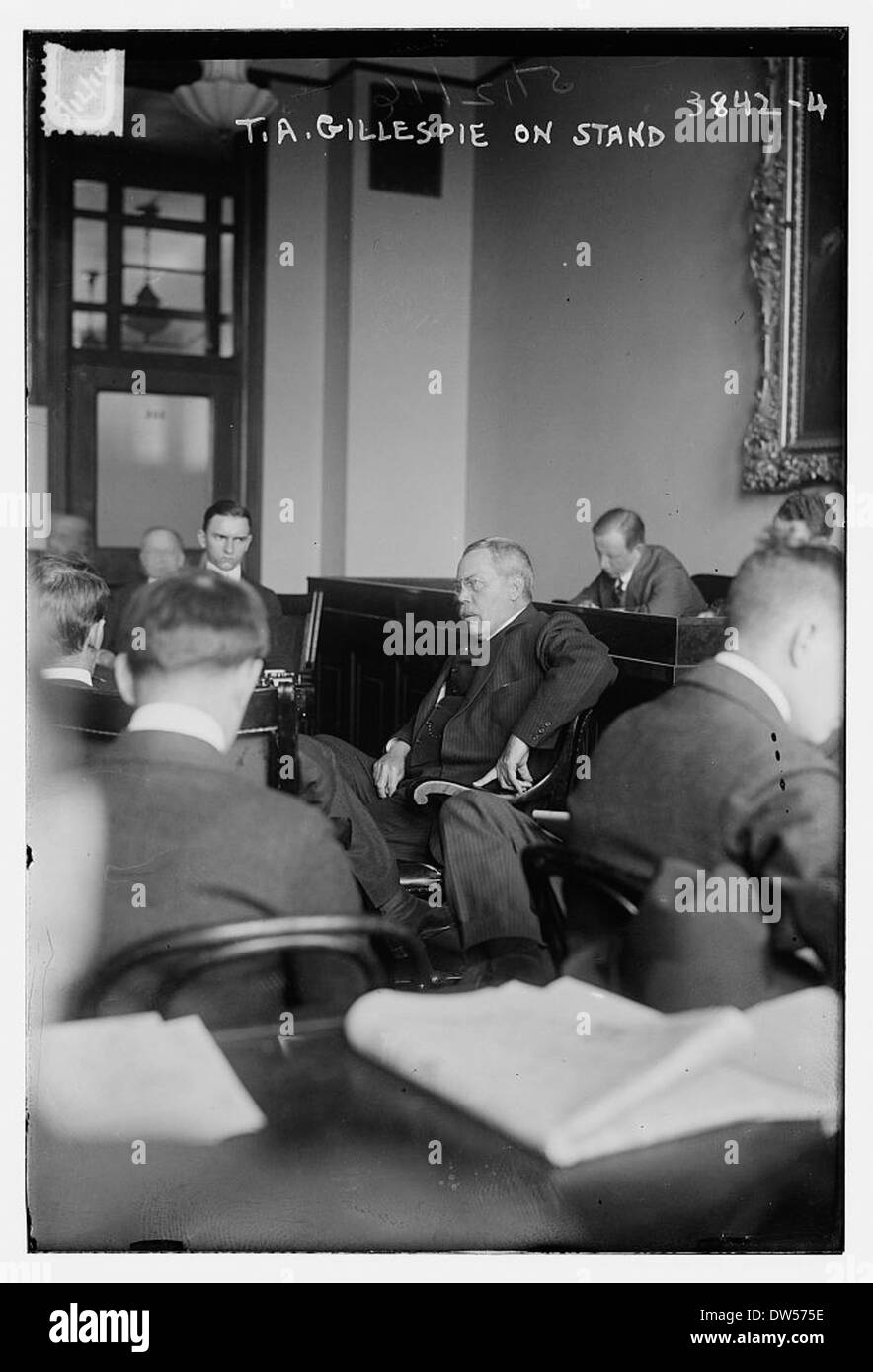 This photograph captures T.A. Gillespie standing in a formal pose, a ...