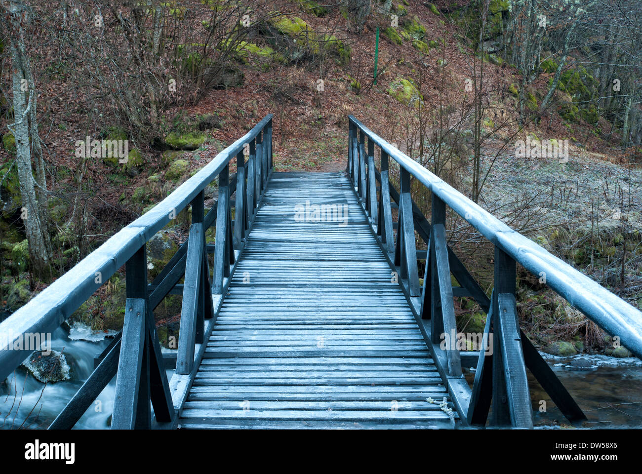 Wooden bridge over the river in the winter Stock Photo - Alamy