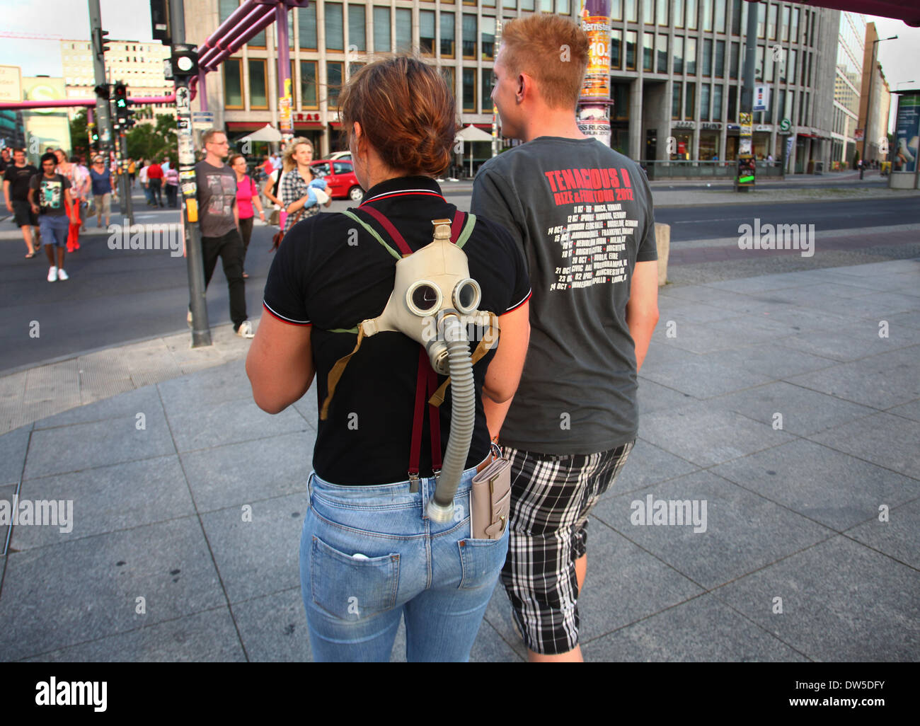 A German tourist carries a gas mask at Potsdamer Platz in Berlin ...