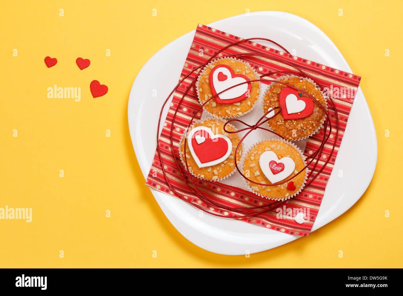 white plate with valentine's day muffins with red and white hearts ...