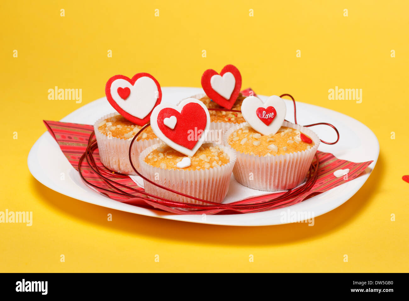 white plate with valentine's day muffins with red and white hearts ...