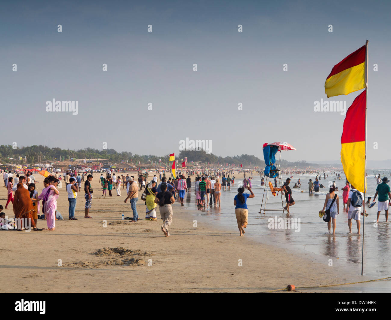 India, Goa, Baga, Indian tourists on the beach, lifeguard between safe ...