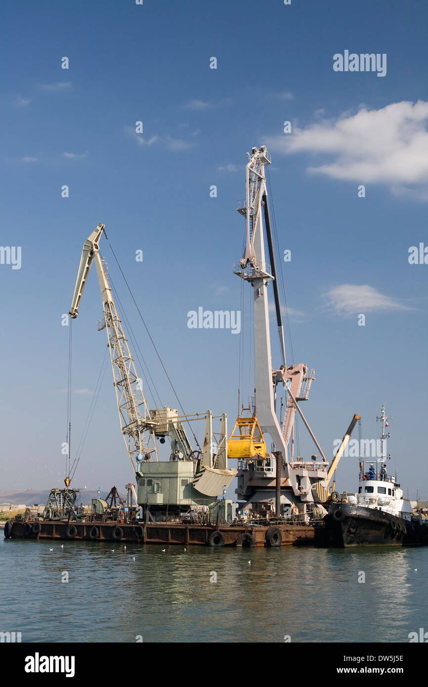 Two white cranes in a harbor on water's edge Stock Photo - Alamy