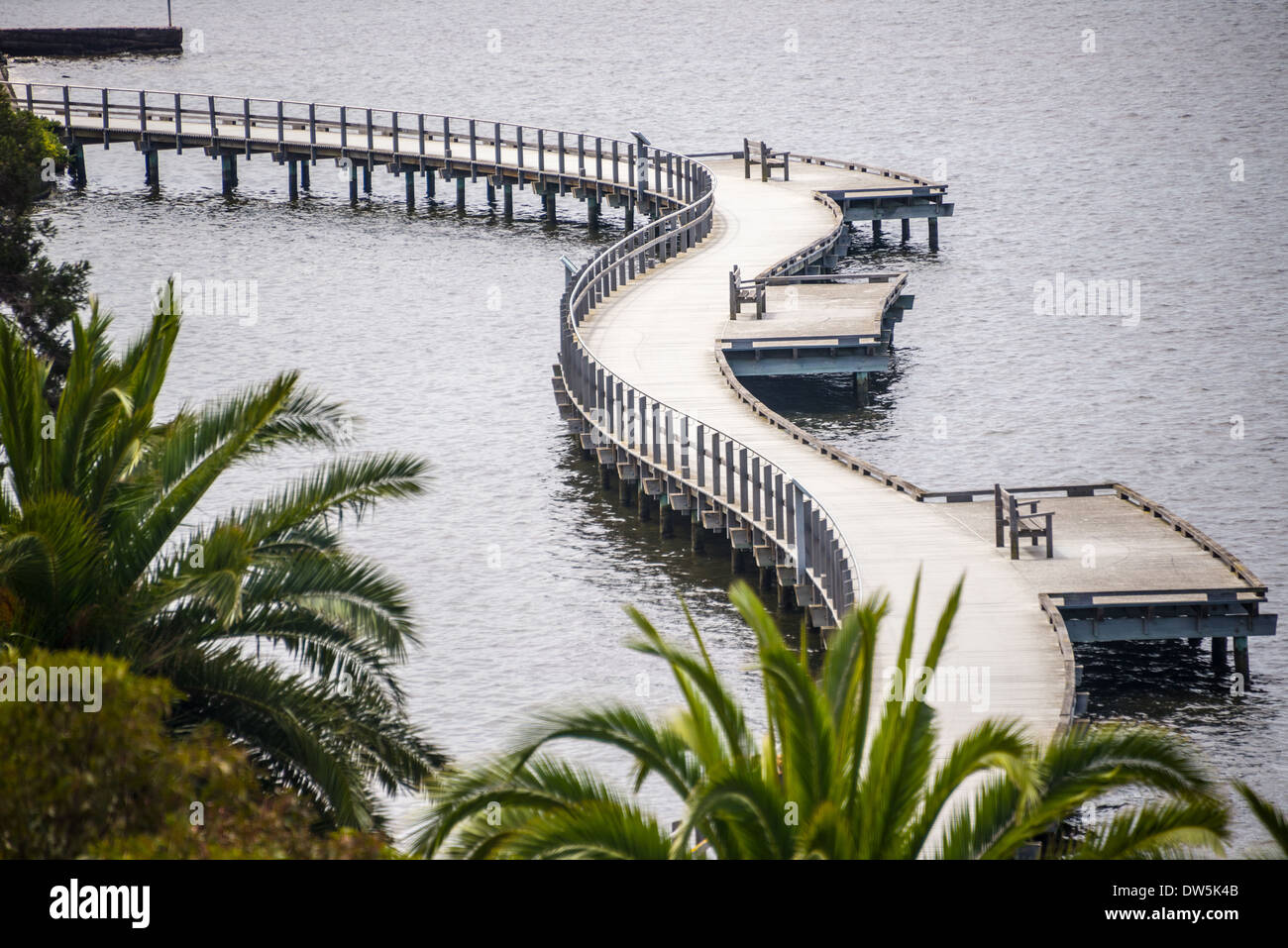 Pier curved on Corio bay western port Geelong with seats made of wood ...