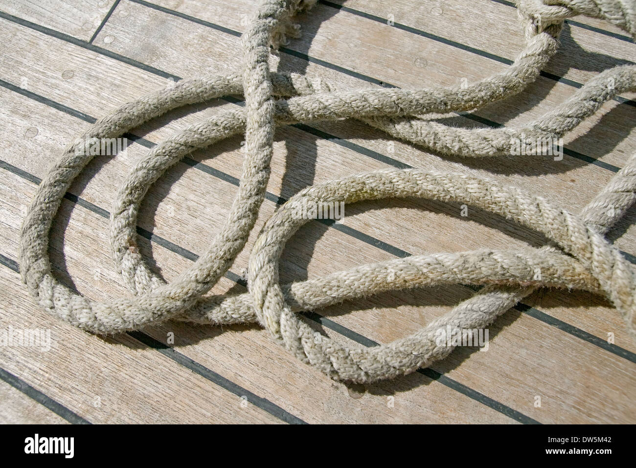 Close-up of thick textile ropes laying on a ship's deck Stock Photo - Alamy
