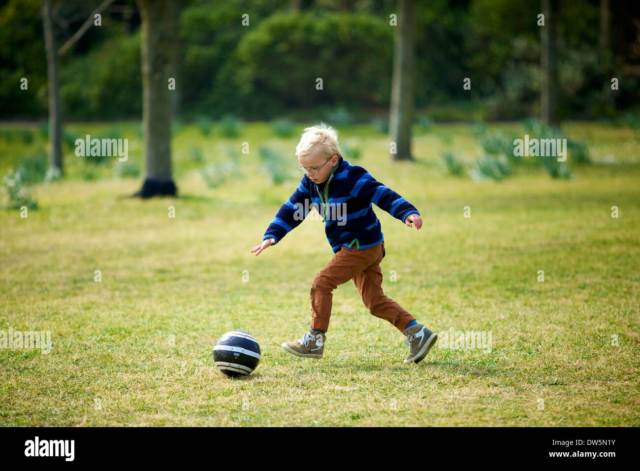 child having fun playing football Stock Photo - Alamy