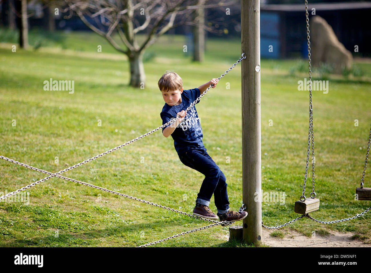 Child playing climbing pole hi-res stock photography and images - Alamy
