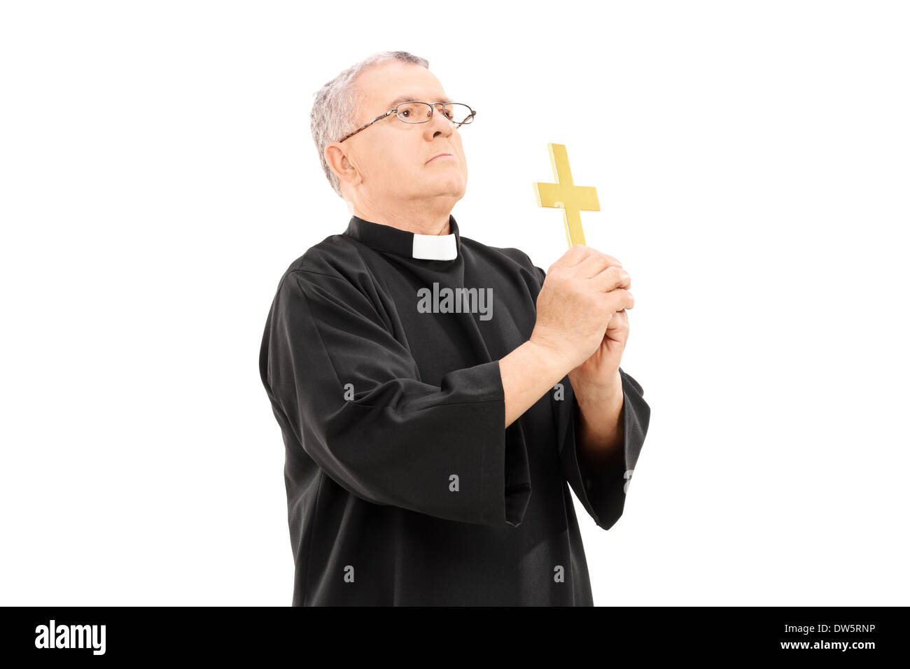 Mature reverend holding a holy cross and praying to god Stock Photo - Alamy