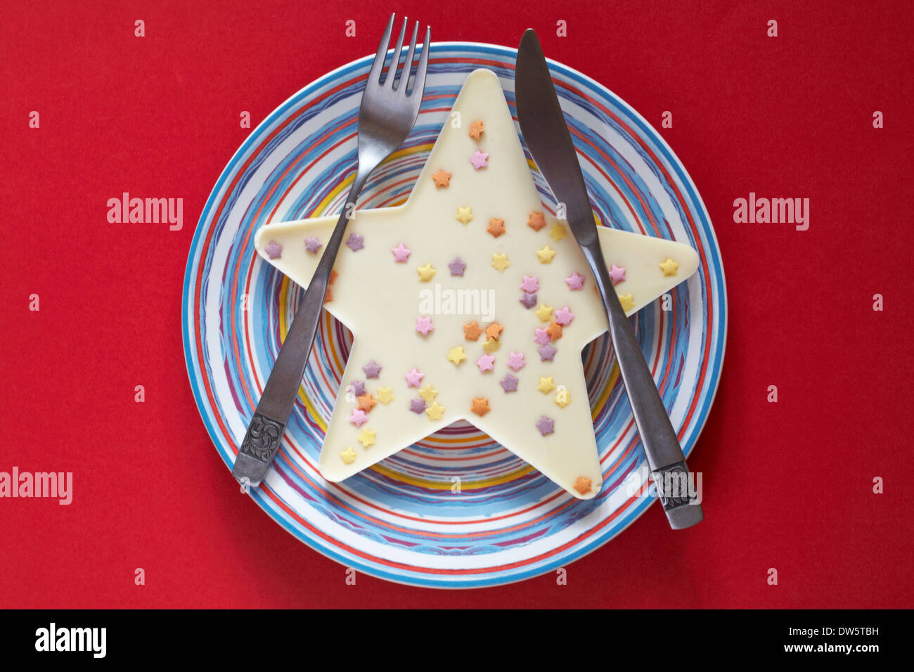 white chocolate star hand decorated with coloured sugar stars set on ...