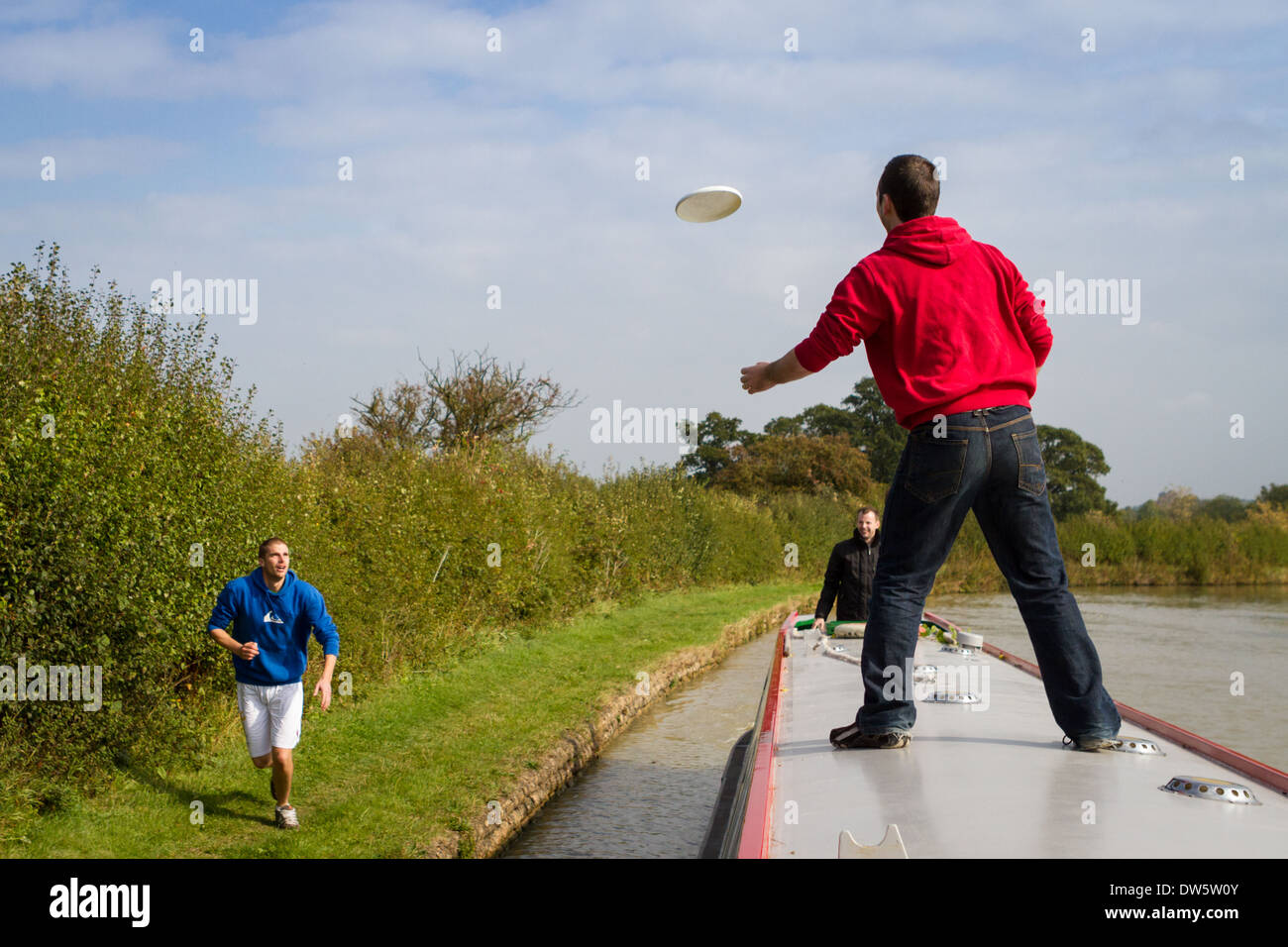 A group of men playing Frisbee on a narrowboat Stock Photo - Alamy