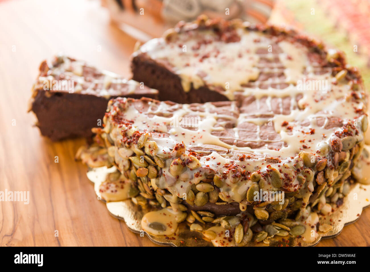 Gourmet Maya Spice torte sliced on a wooden cutting board Stock Photo ...