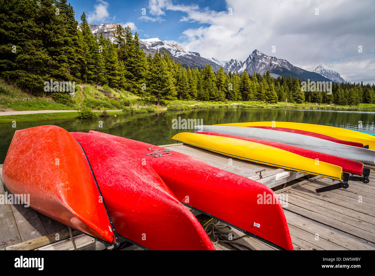 Colorful canoes at the dock at the Maligne Lake boat dock in Jasper ...