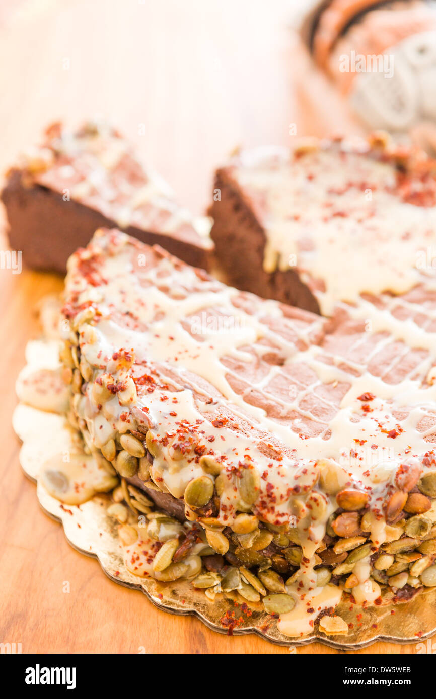 Gourmet Maya Spice torte sliced on a wooden cutting board Stock Photo ...