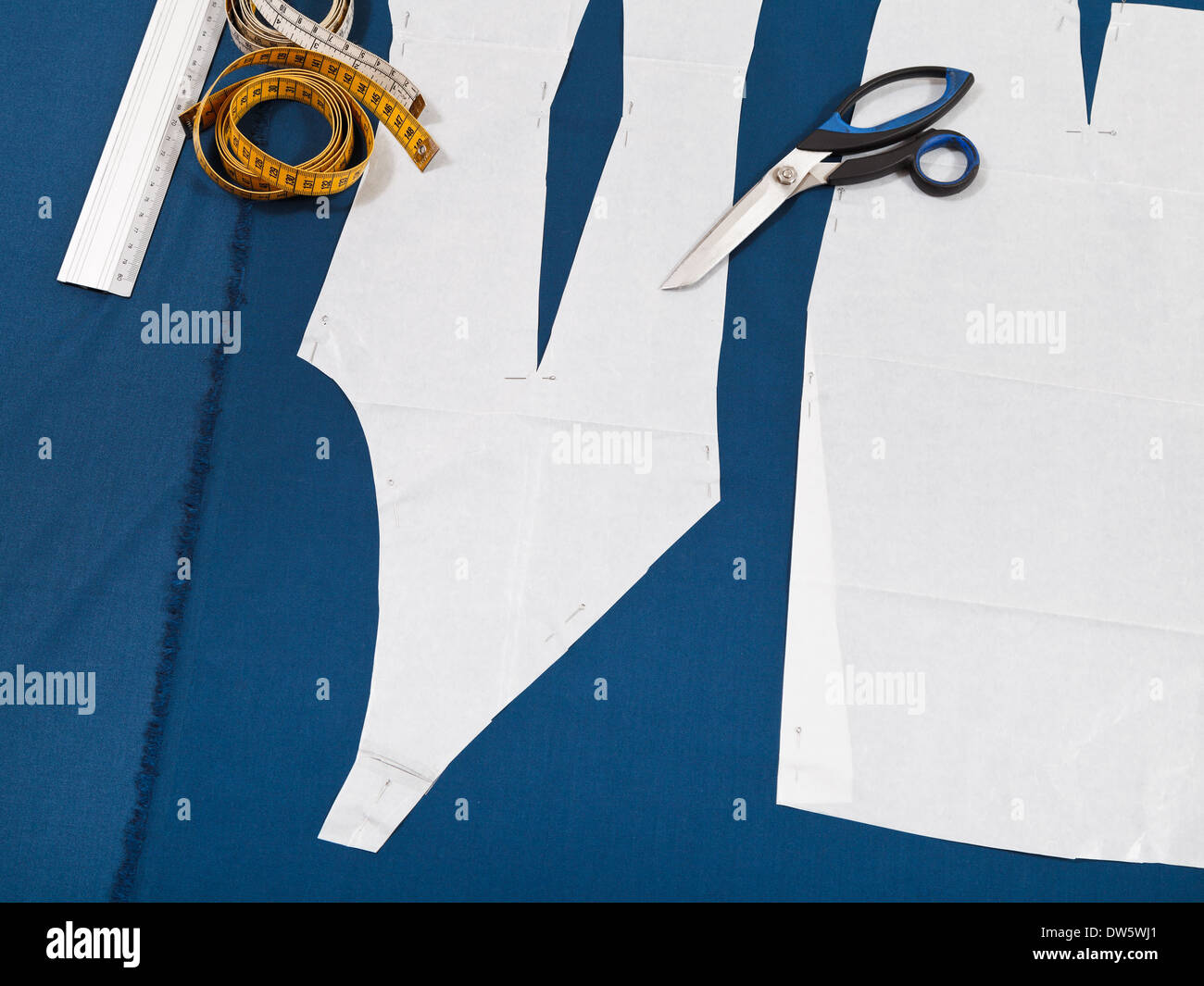 tailor tools and paper model of clothes on blue fabric for dress ...