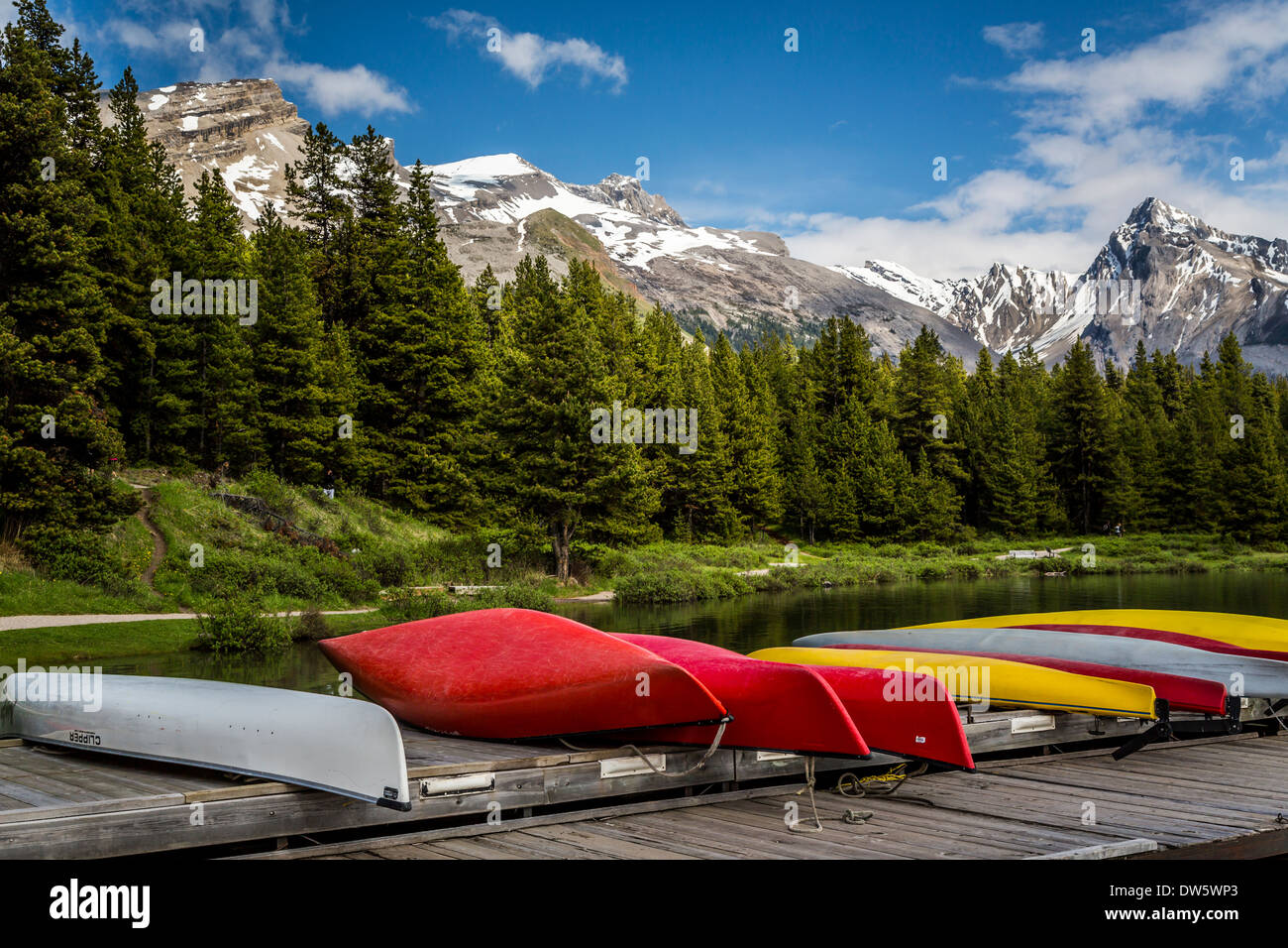 Colorful canoes at the dock at the Maligne Lake boat dock in Jasper ...